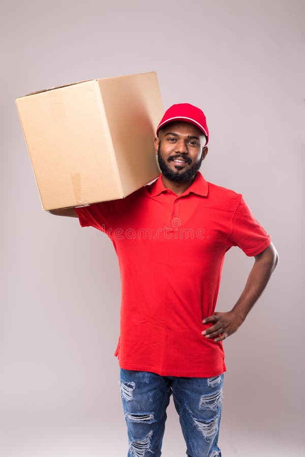 Side View of Young Delivery Man with Box Gray Background Stock Photo ...