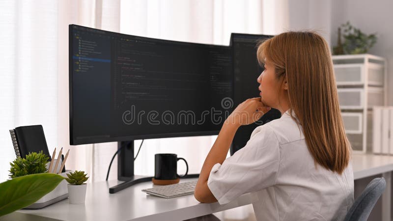 Side View Of Young Developer Looking At Coded Data On Computer Screen Developing Programming