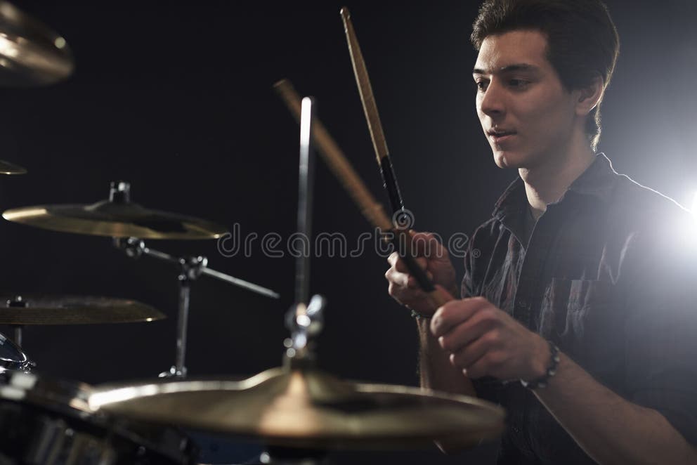 Side View of Young Drummer Playing Drum Kit in Studio Stock Photo ...
