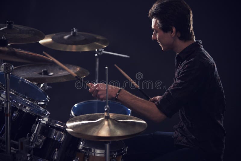 Side View of Young Drummer Playing Drum Kit in Studio Stock Photo ...