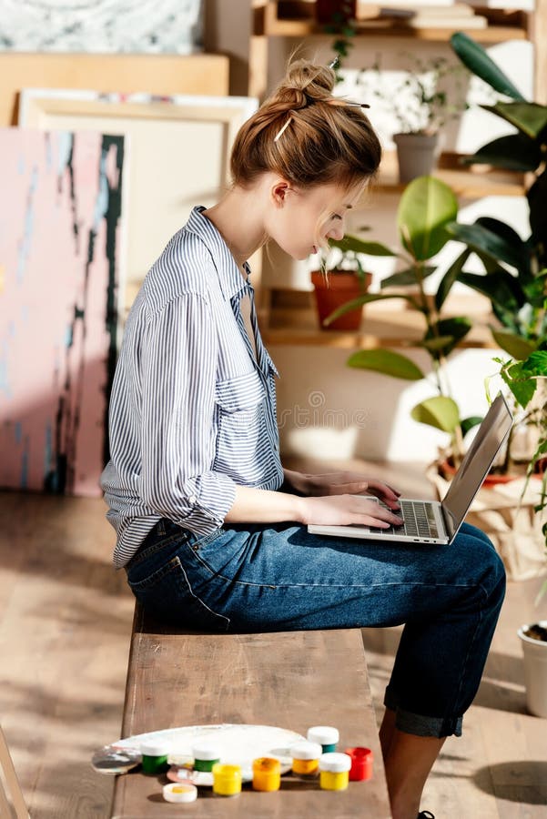 Side View of Young Female Artist Sitting on Bench with Paints Stock ... Side View of Young Female Artist Sitting on Bench with Paints Stock ...