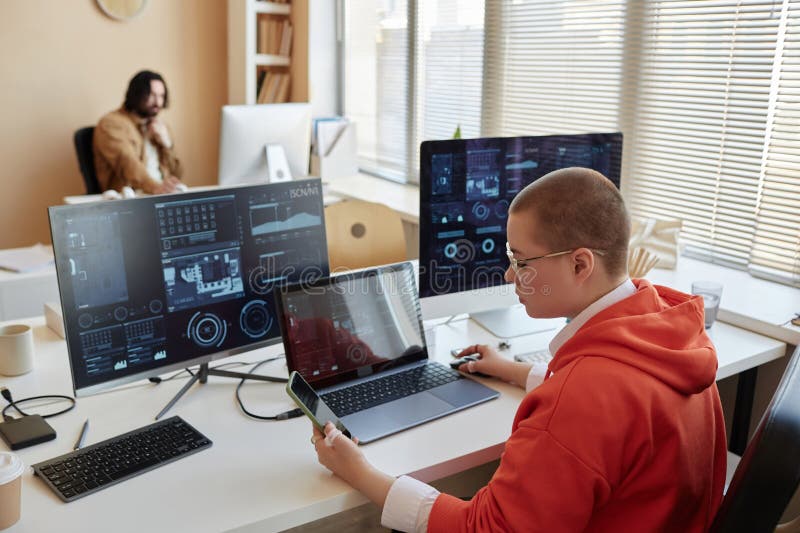 Side View of Young Female Cyber Security Engineer Using Smartphone ...