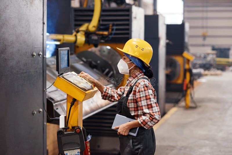 Side View of Young Female Engineer Looking through Information by ...