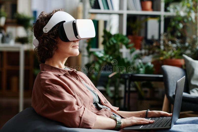 Side View of Young Female Programmer in Vr Headset Using Laptop Stock ...