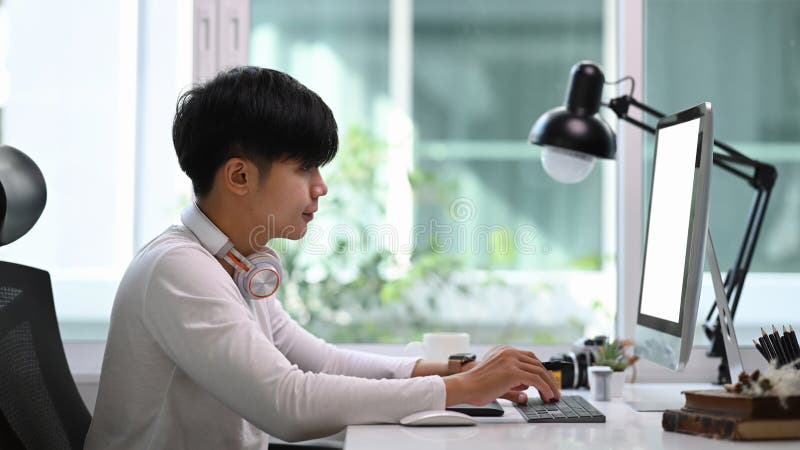 A Young Graphic Designer Sitting at Graphic Studio in Front of Computer ...