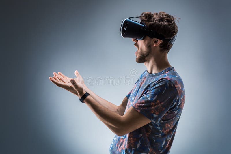 Side View Of A Young Guy Using A VR Headset. Emotions Stock Photo ...