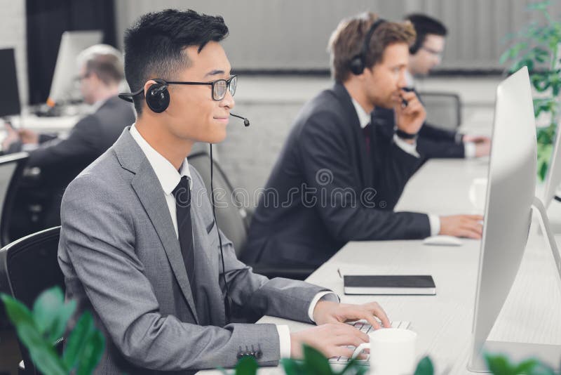 Side View of Young Male Call Center Operators Working Together Stock ...