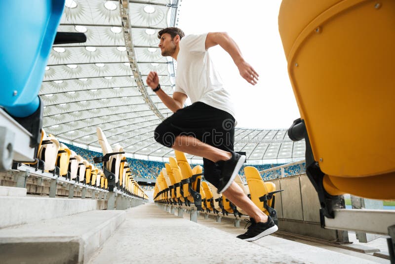 Side View of a Young Male Runner Running Upstairs Stock Photo - Image ...