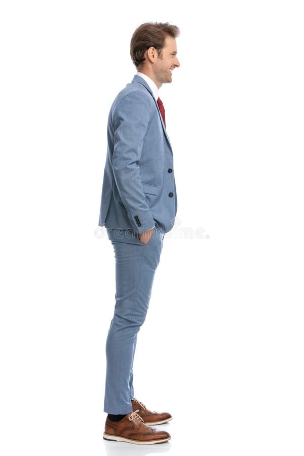 Side View of Young Man in Blue Suit Holding Hands in Pockets and ...