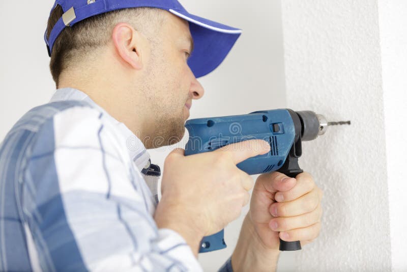 Side View Young Man Drilling Wall with Electric Drill Stock Image ...