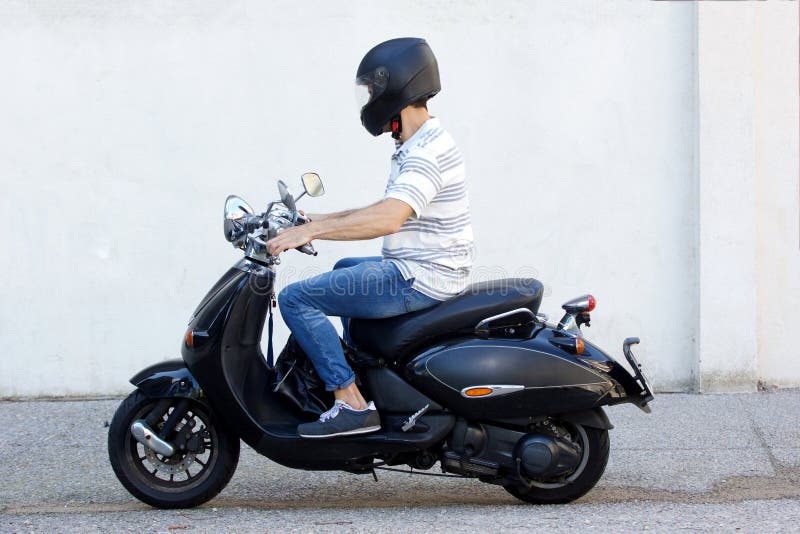 Side View of Young Man in Helmet Riding a Scooter on Road Stock Image ...