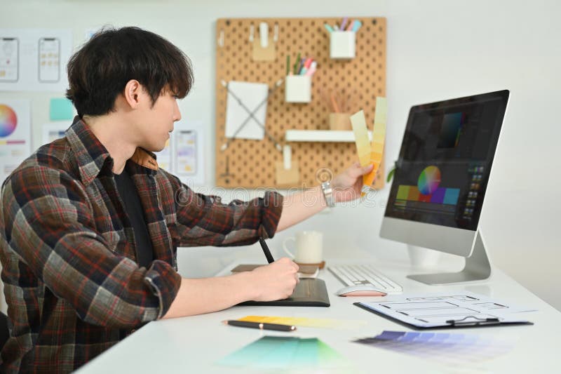 Side View of Young Man UX Graphic Designer Working Together for Mobile ...