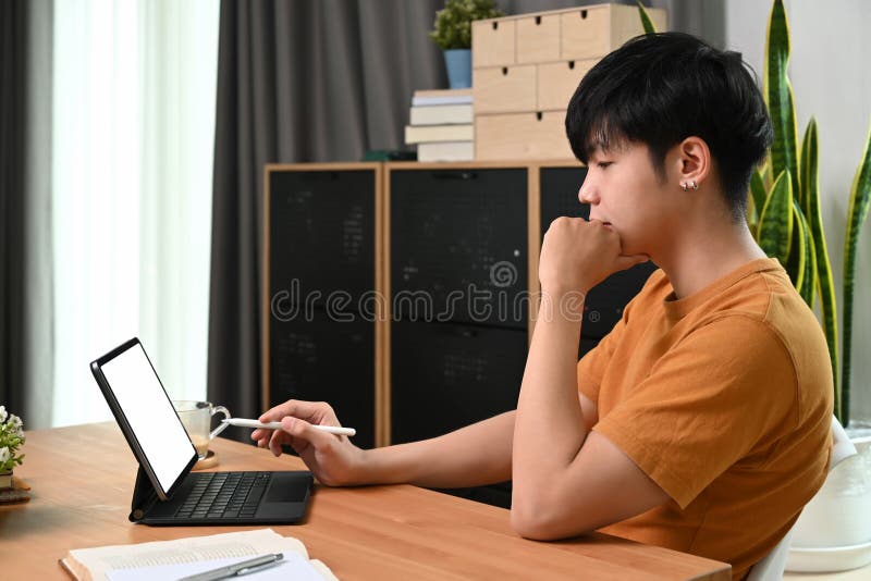 Young Man Working with Computer Tablet at Home. Stock Image - Image of ...