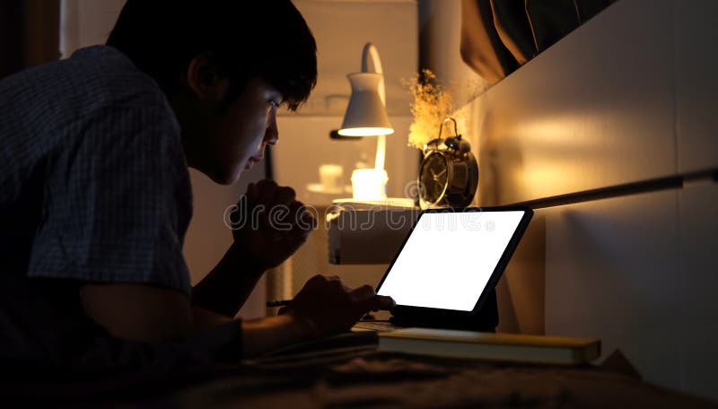 Side View Young Man Working with Computer Tablet at Late Night on Bed ...