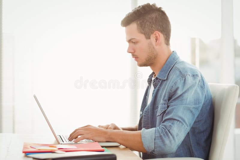 Side View of Young Man Working on Laptop Stock Photo - Image of ...