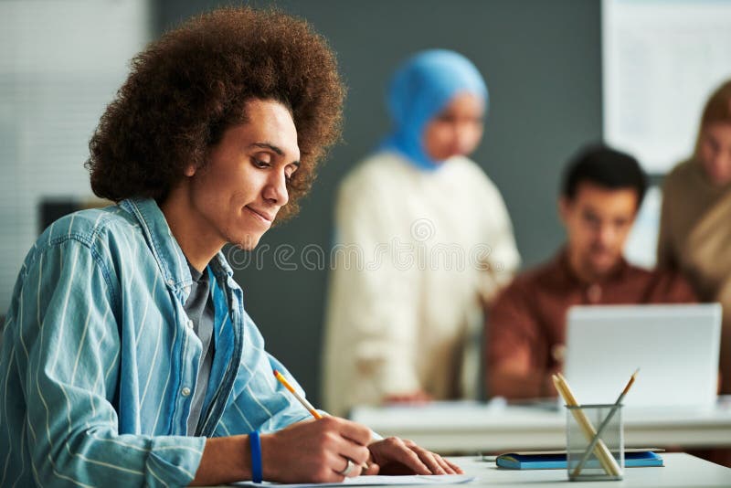 Side View of Young Multi-ethnic Student Looking at Paper with Grammar ...