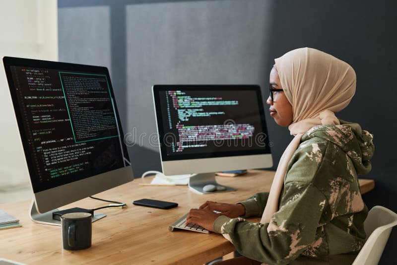 Side View of Young Muslim Female Programmer Looking through Coded ... Side View of Young Muslim Female Programmer Looking through Coded ...