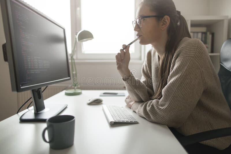 Side View of Young Programmer Working on Computer Codes from Her Home ...