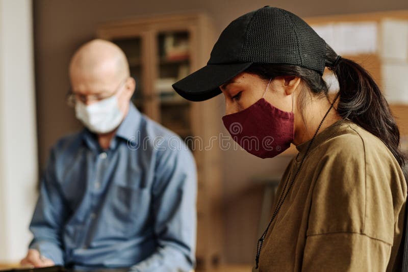 Side View of Young Upset Woman in Protective Mask and Baseball Cap ...
