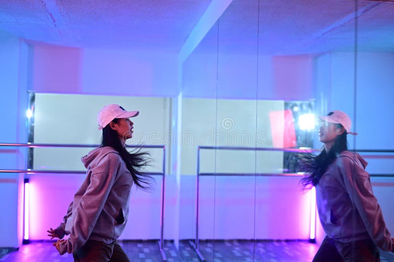 Side View of Young Woman Practicing Dance in Front of Mirror at Studio ...