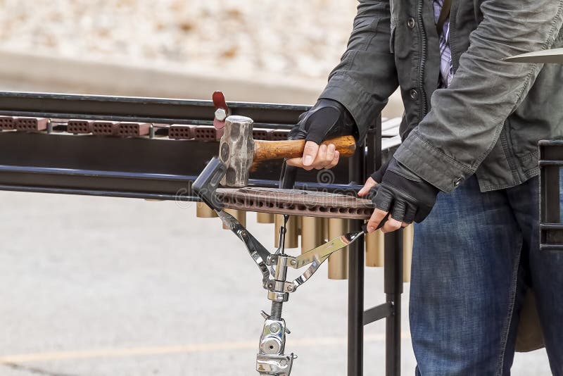 Sideline Percussionist Rapping on a Metal Plate with a Hammer Stock ...