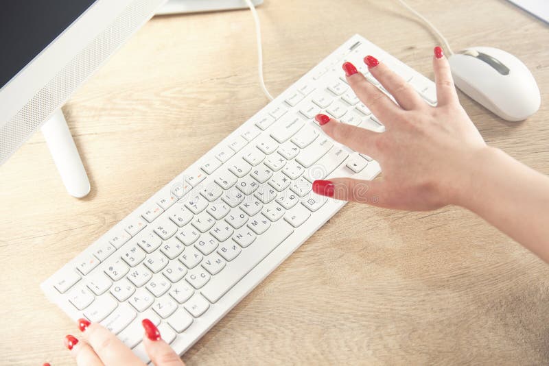 Sideview of Female Hands Using Computer on Table with Glasses and Other ...