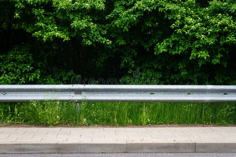 Sidewalk, Highway Guard Rail, Green Grass and Bushes Stock Photo ...