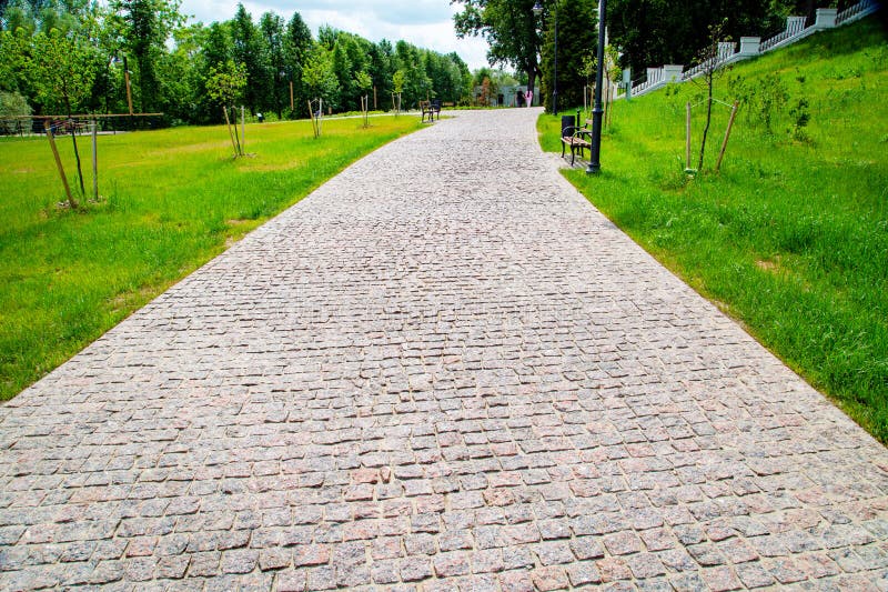 A Sidewalk Made of Rectangular Natural Stone Stretching into the ...