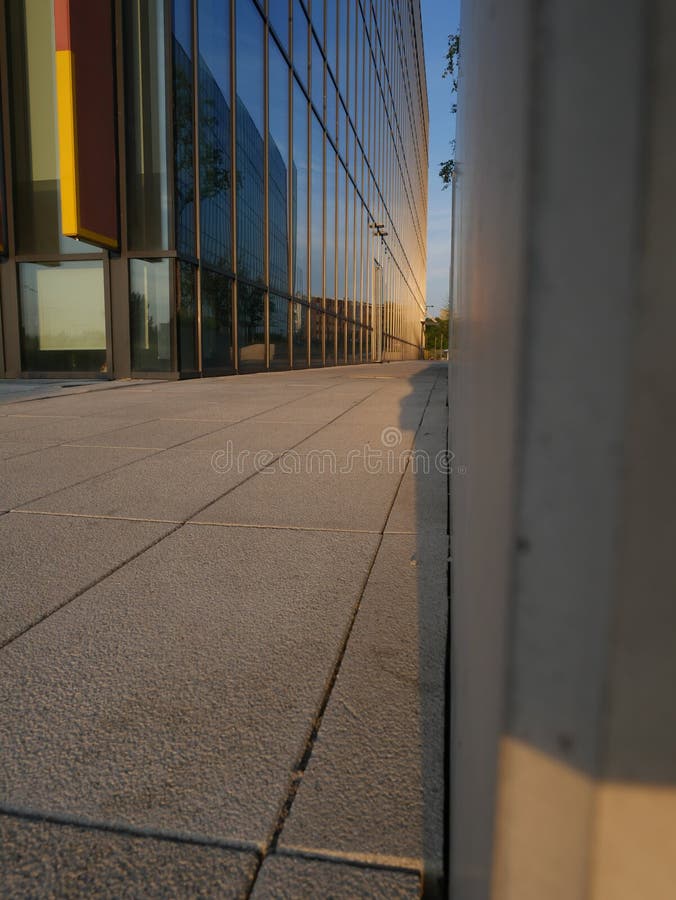 A Sidewalk Next To an Office Building Made of Glass Editorial Image ...