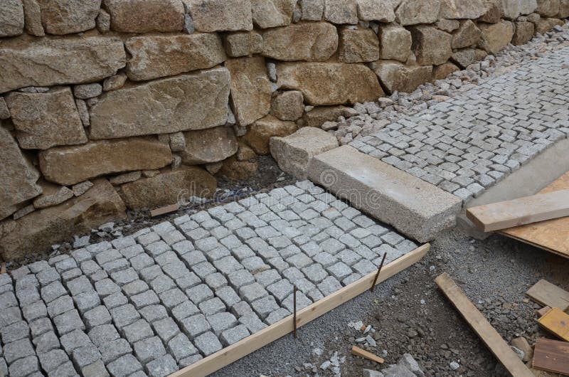 Sidewalk, Ramp Under a Stone Retaining Wall. Rows of Granite Blocks ...
