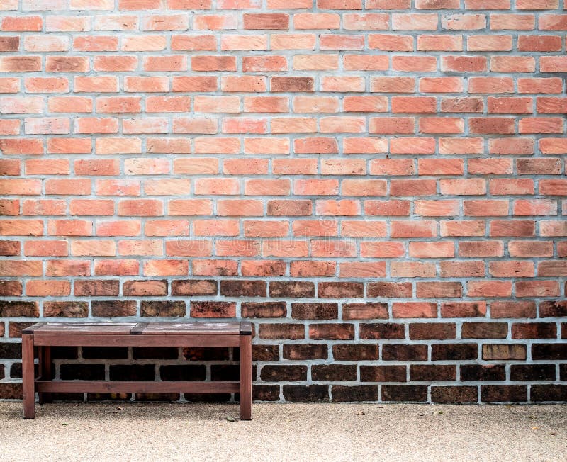 Sidewalk Scene with Wooden Bench and Red Brick Wall Stock Image - Image ...