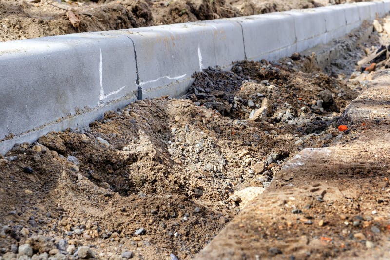 A Sidewalk is Under Construction, a Concrete Curb is Being Installed ...