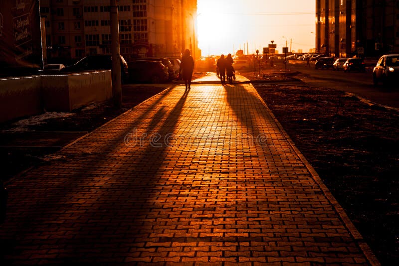 Sidewalk with Walking People after Work in Back Light during the Sunset ...