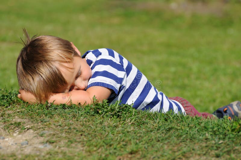 Siesta on grass stock photo. Image of tshirt, striped - 26697108