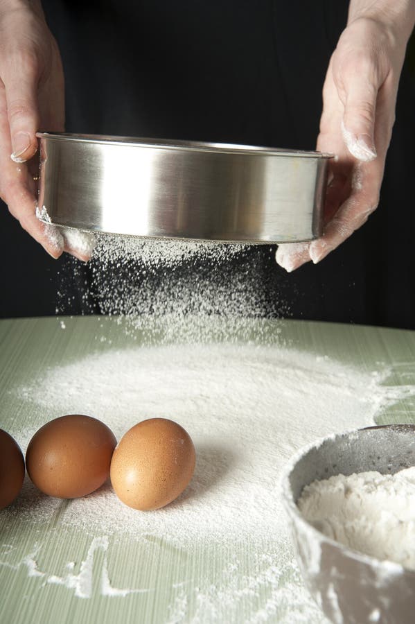 Sifting Flour through a Sieve Stock Photo - Image of closeup ...