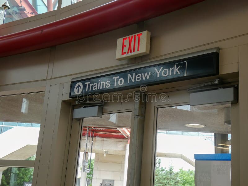 Sign with an Arrow Indicating the Direction To Trains To New York Over ...