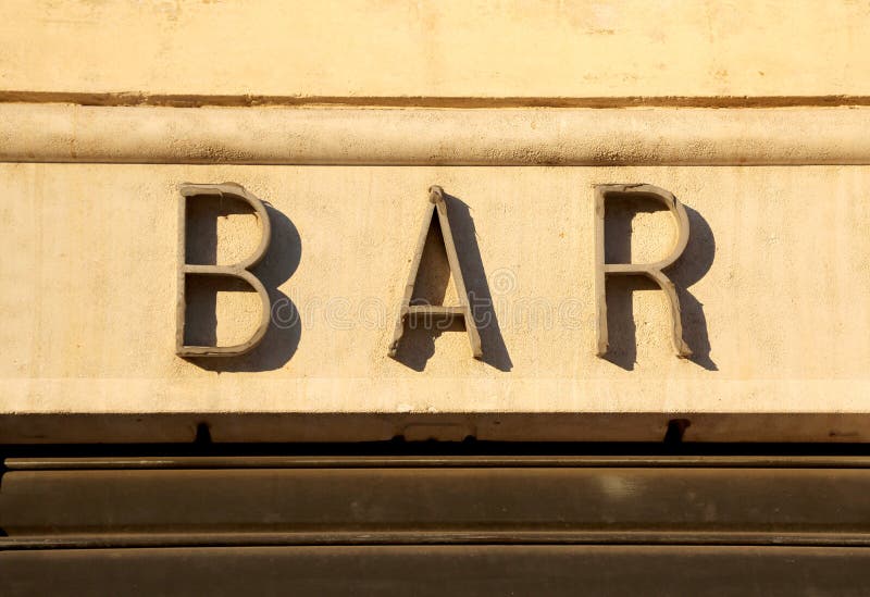 Sign of BAR in Big Letters on the Wall of the Building Stock Photo ...