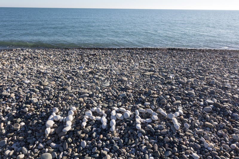 The Sign Be Happy Made from White Pebbles on Pebble Beach on the Stock ...