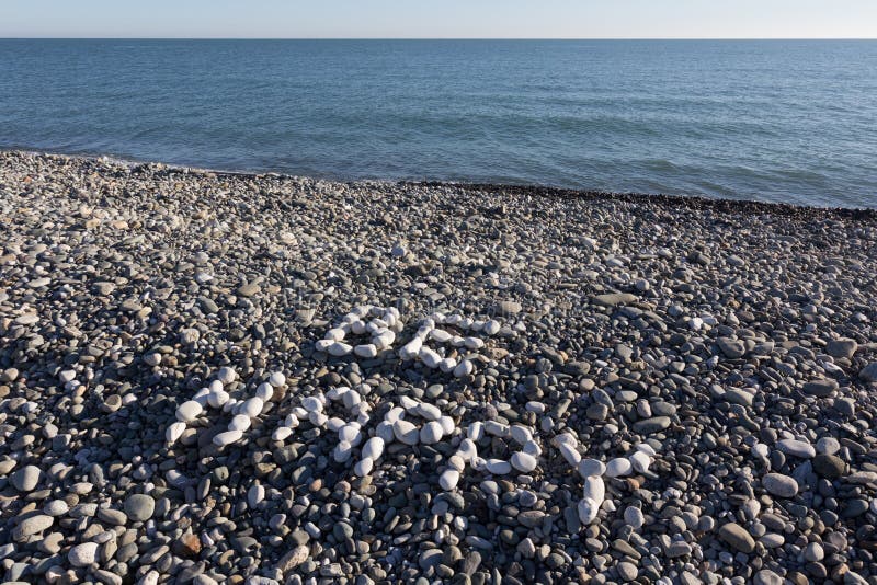 The Sign Be Happy Made from White Pebbles on Pebble Beach on the Stock ...