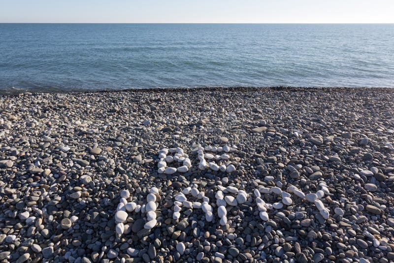 The Sign Be Happy Made from White Pebbles on Pebble Beach on the Stock ...