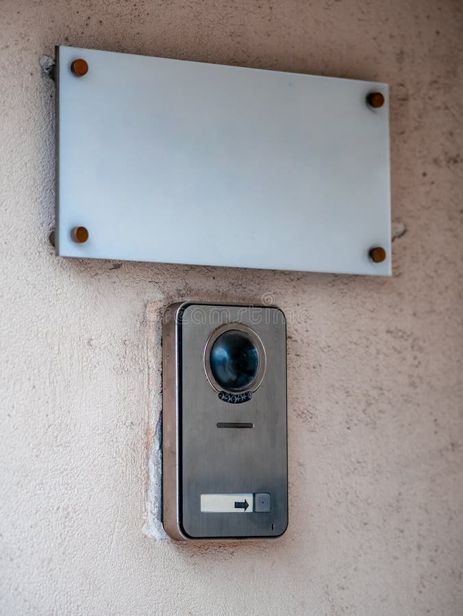 A Sign Board on Wall of the Building and a Call Button for Staff. White ...