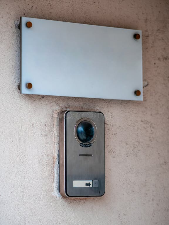 A Sign Board on Wall of the Building and a Call Button for Staff. White ...