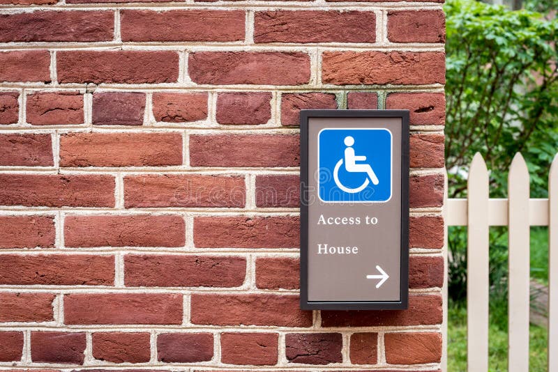 Sign Directing the Handicap Mounted on a Brick Wall Stock Photo - Image ...