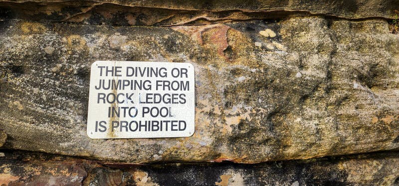 A Sign about the Diving or Jumping from Rock Ledges into Pool is ...