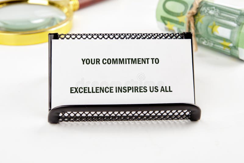 A Sign Emphasizes the Importance of Commitment To Excellence in a Workplace, Placed Alongside ...