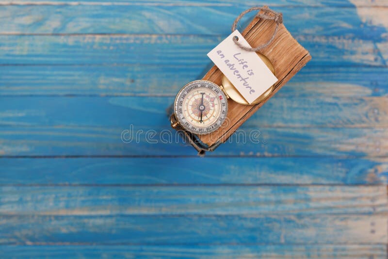 Sign Life is an Adventure and Compass on Old Book - Vintage Style Stock ...