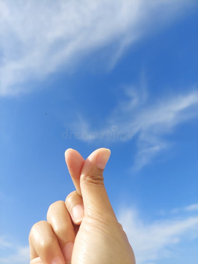 A Sign of Love by Hand in the Blue Sky Stock Image - Image of blue ...