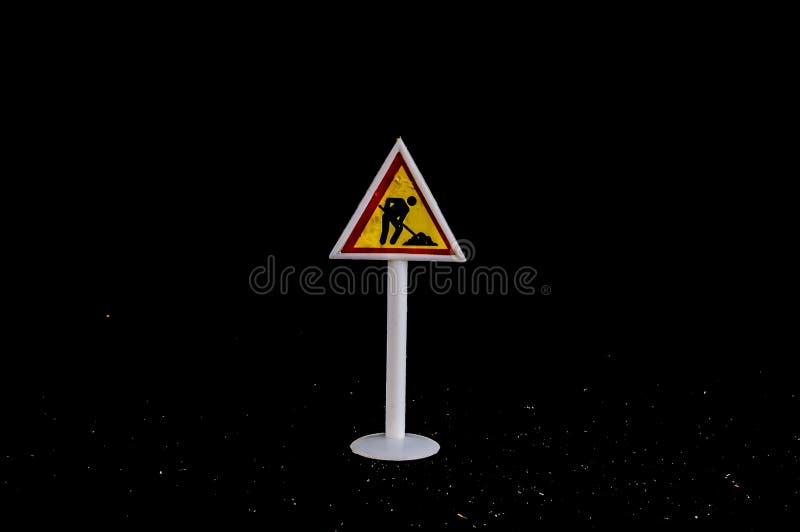 A Sign with a Man in a Black Silhouette and a Triangle with a Yellow ...