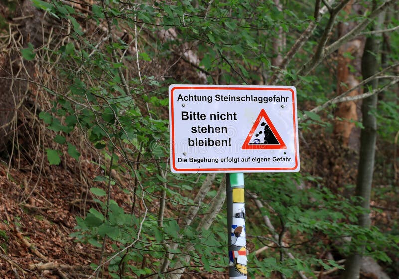 Sign with Please Do Not Stop. Attention, Danger of Falling Rocks Stock ...