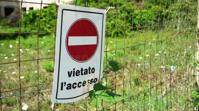 Sign Prohibited in Italian Written on a Wire Mesh in the Sun Stock ...